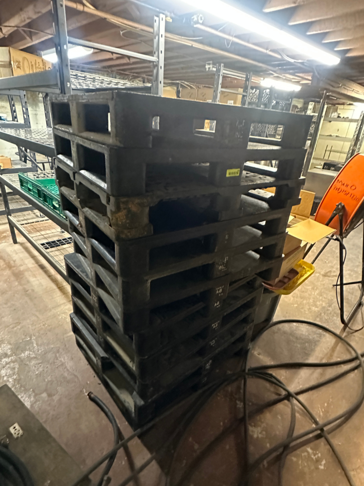 (10) BLACK PLASTIC SHIPPING PALLETS.